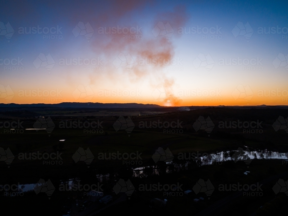 Image of bushfire smoke on horizon after sunset - Austockphoto