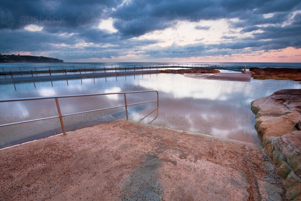 Image of Calm waters and reflections over tidal swimming baths in soft ...