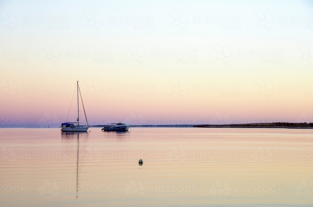 Image of Calm Waters for a fishing boat in the early morning hours ...