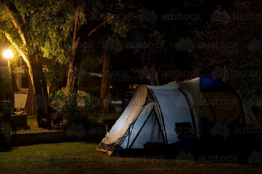Image of Campground tent illuminated at night. - Austockphoto