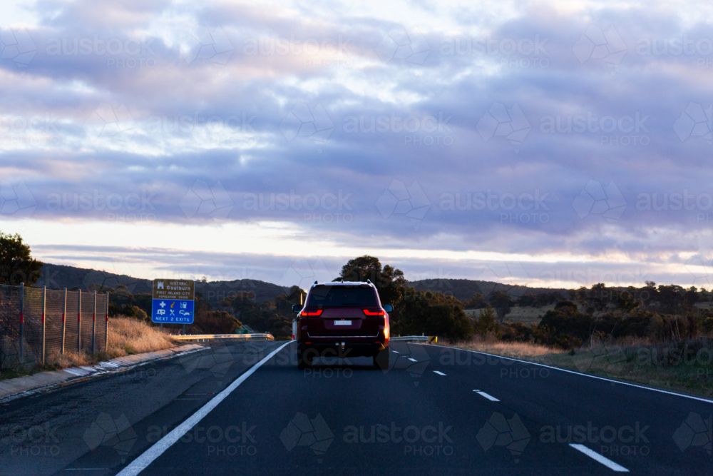 Image of Car on road trip adventure at dusk driving on rural road near ...