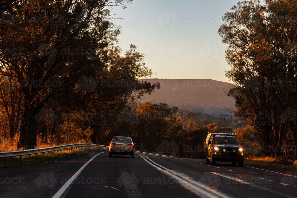 Image of car on road trip traveling down country highway with sunset ...