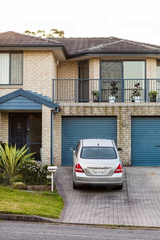 Image of car parked in driveway of home with double garage and two ...