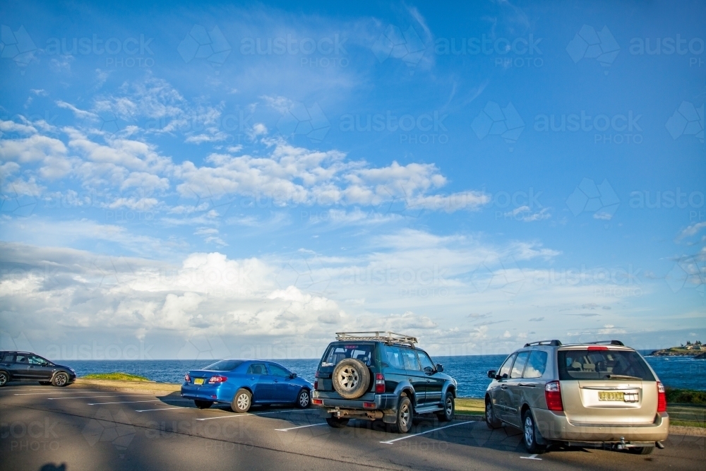 Image of Car parked over the lines in coastal car park with large sky ...