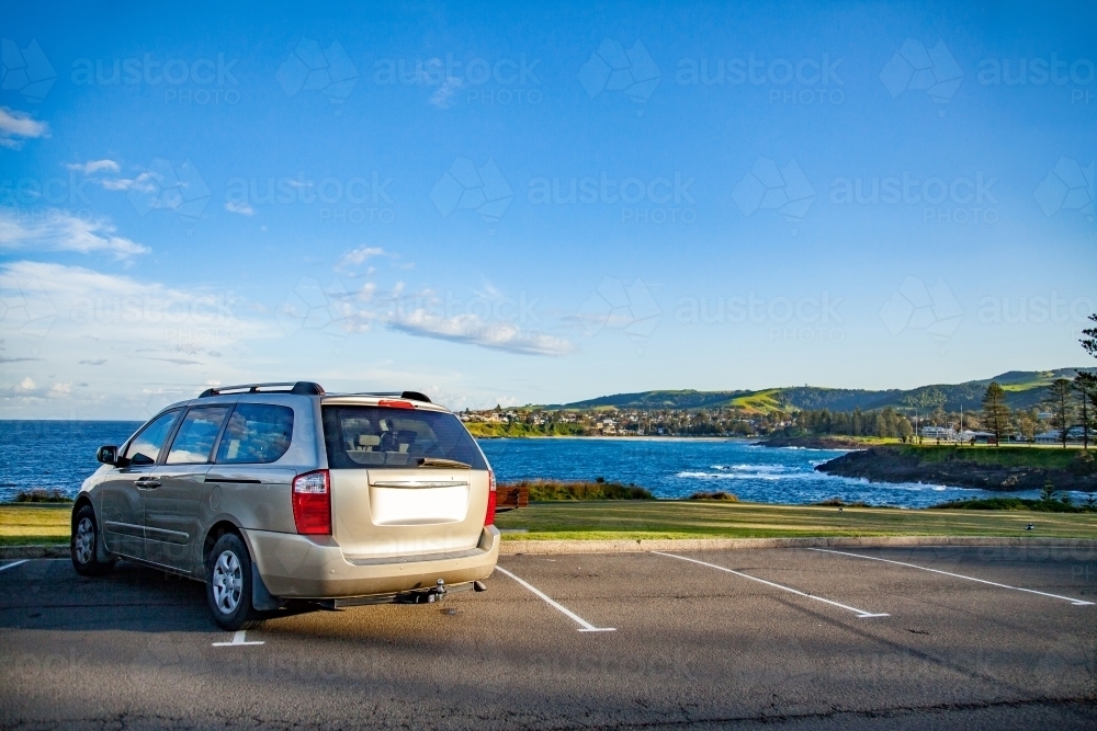 Image of Car parked over the lines in coastal car park with large sky ...