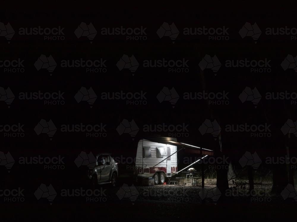 Image of Caravan partially lit at night - Austockphoto