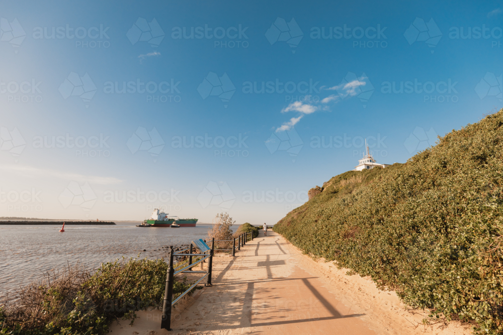 Image of Cargo ship escorted by tug boats as it leaves Newcastle Port ...