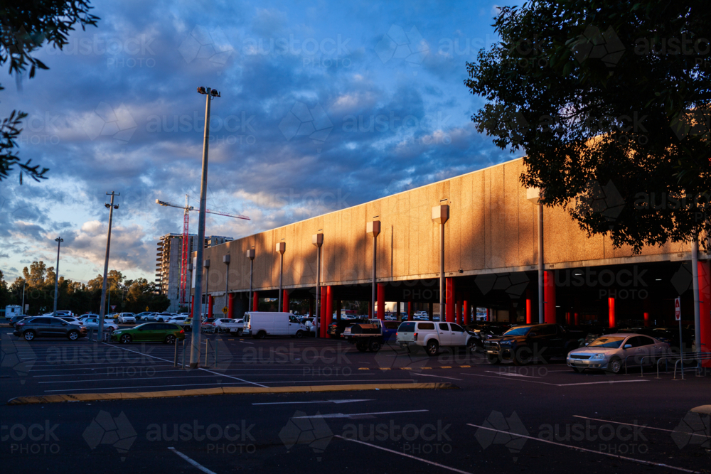 Image of Carpark and shopping centre with apartment building under ...