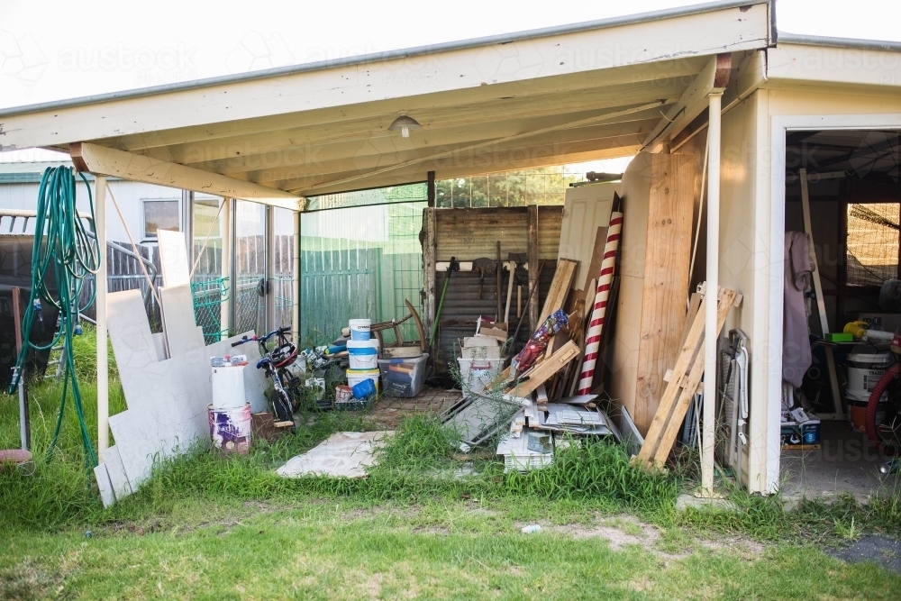 Image of Carport filled with mess and scrap wood - Austockphoto