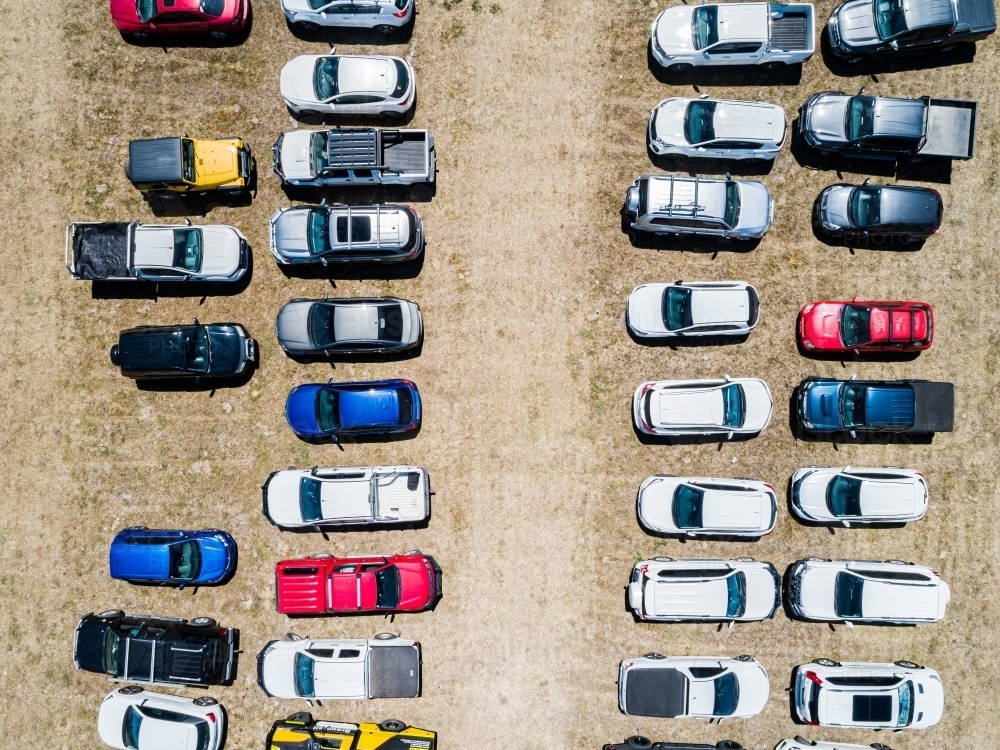 Image of Cars in overflow carpark in paddock top down - Austockphoto