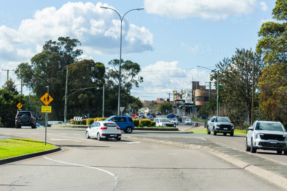 Image of cars on roundabout in urban area - Austockphoto