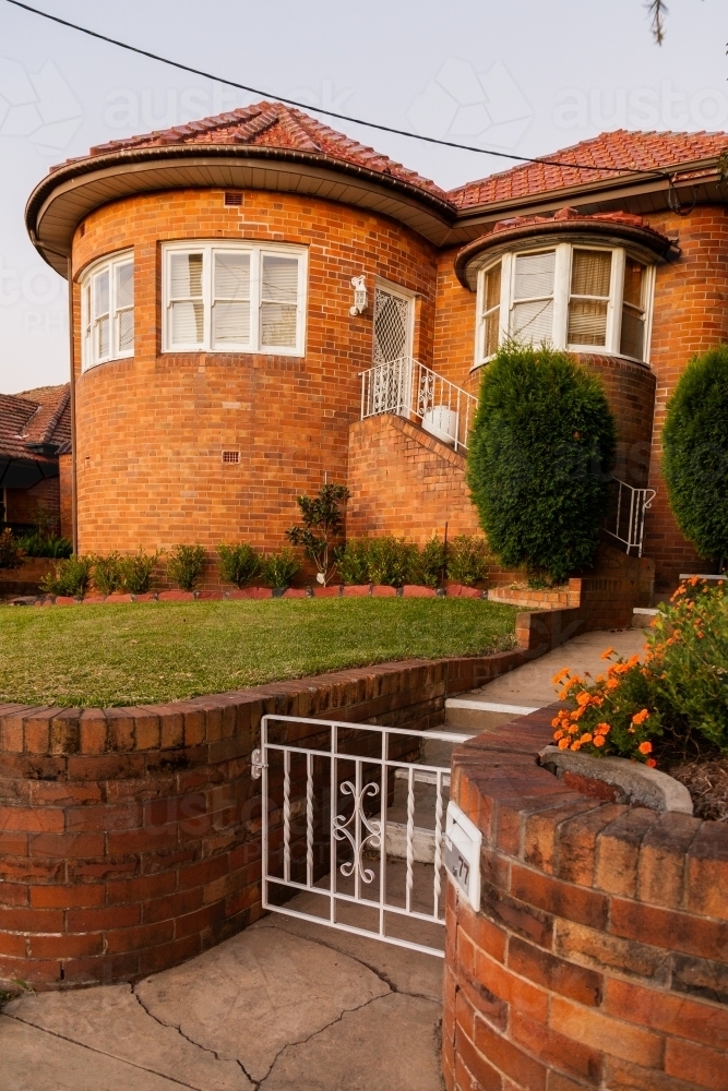 Image of Castle shaped home with rounded walls and pathway and gate ...