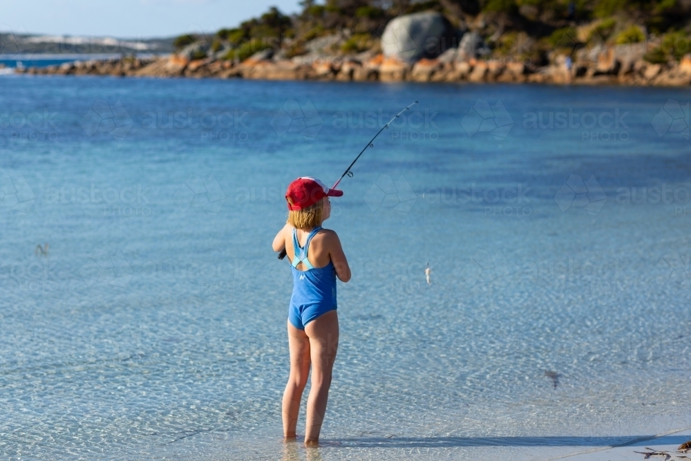 Image of Child from behind with fishing rod at the seaside - Austockphoto