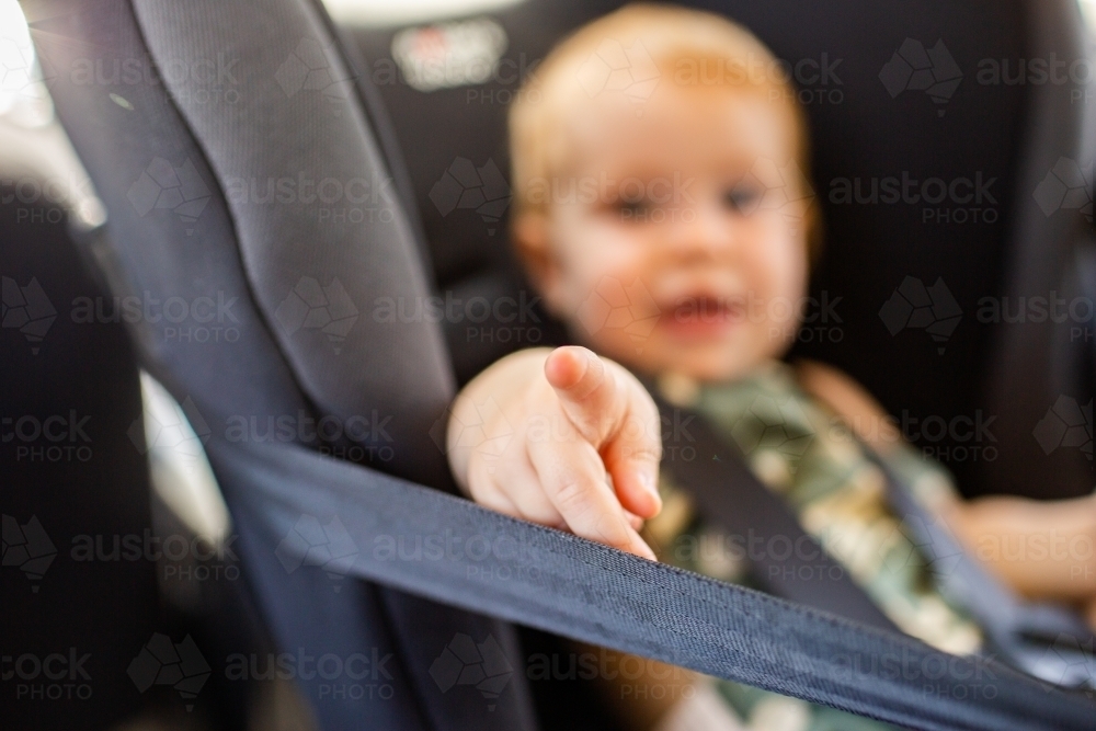 Image of Child in baby rear facing car seat pointing to camera ...