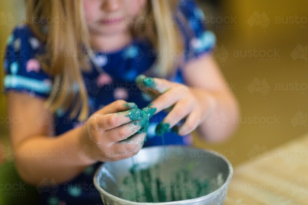 Image of Child playing with green slime on fingers - Austockphoto