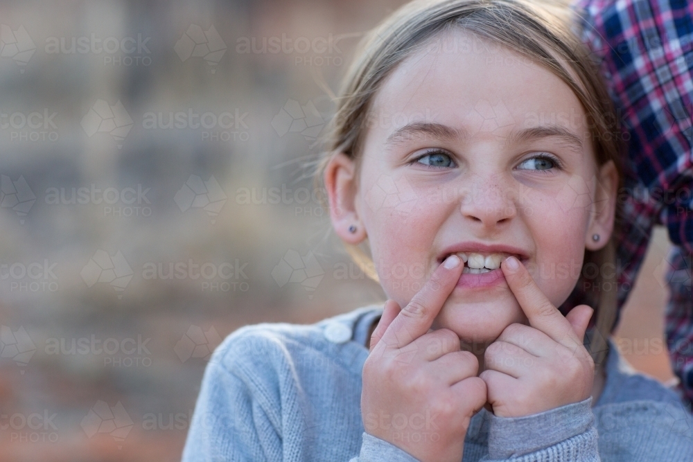Image of Child pointing to two front teeth - Austockphoto