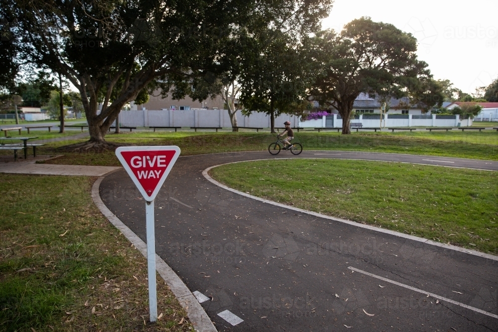 Image of child riding a bike on a suburban bike track with a give way ...