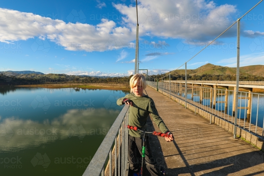 Image of Child riding scooters on the Rail Trail bridge crossing over ...