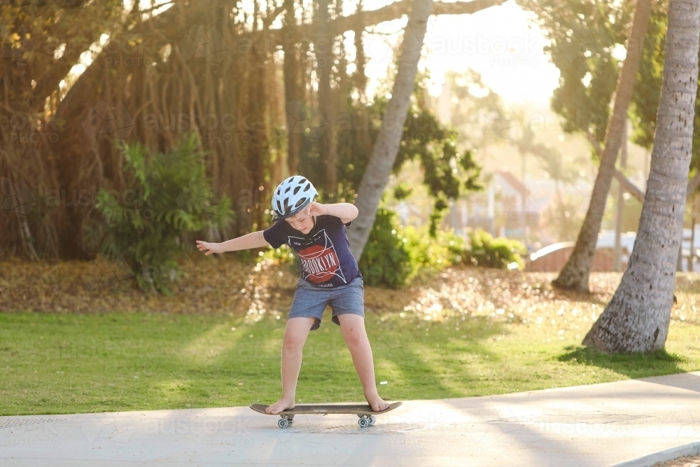 Image of Child riding skate board on the esplanade at Airlie Beach ...