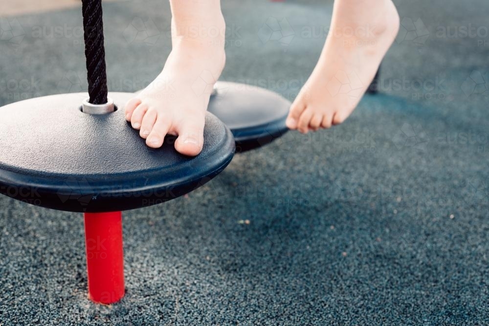 Image of child's feet on playground equipment - Austockphoto