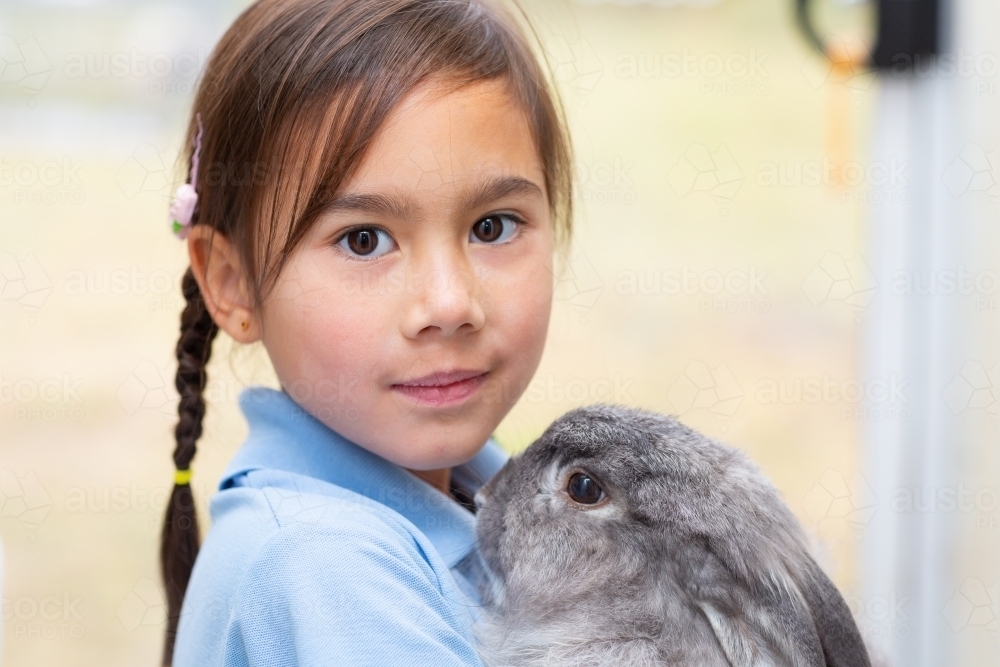 Image of Child with pet rabbit - Austockphoto