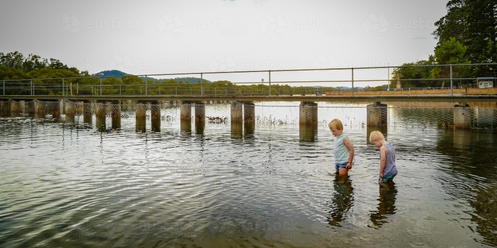 Image of Children paddling in shallow water on the Central Coast ...