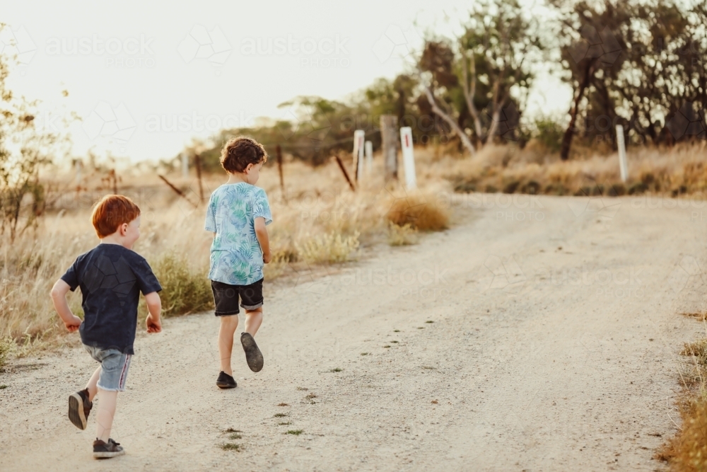 Image of Children running along gravel road in the countryside ...