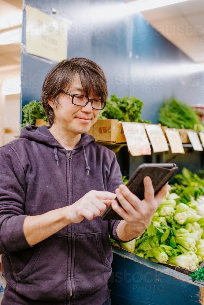 Image of Chinese man working in fresh food store - Austockphoto