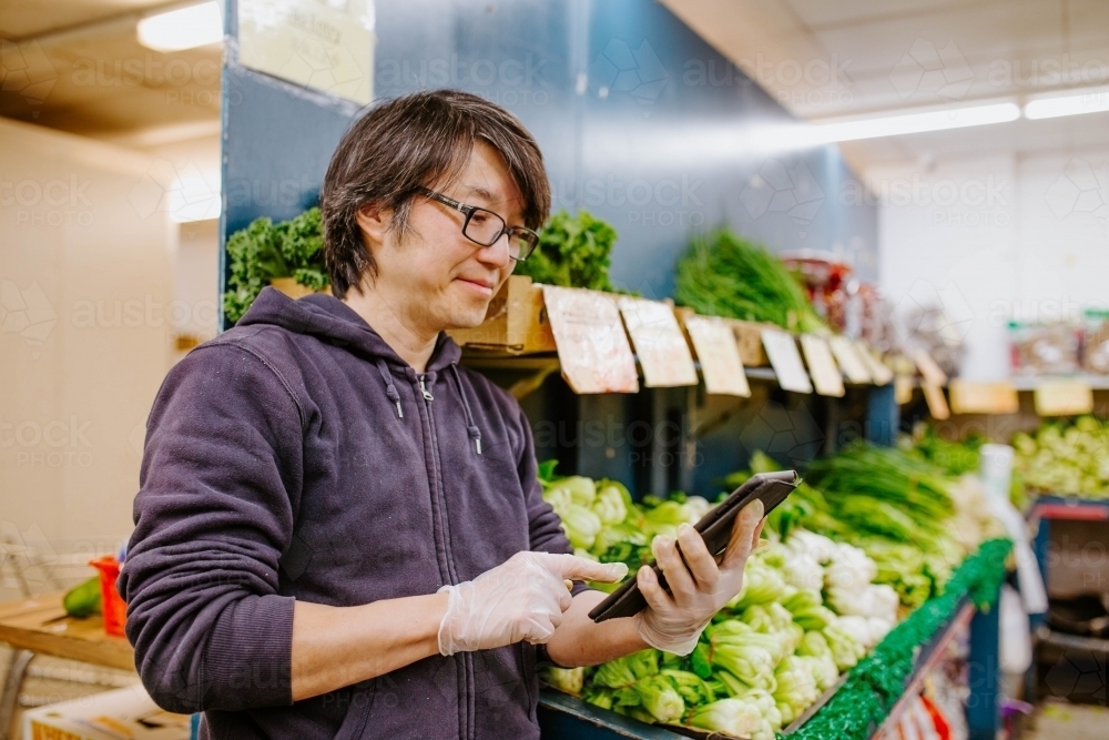 Image of Chinese man working in fresh food store - Austockphoto