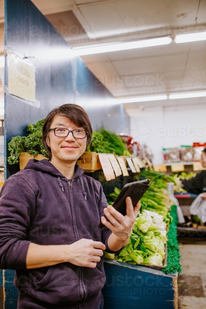 Image of Chinese man working in fresh food store - Austockphoto