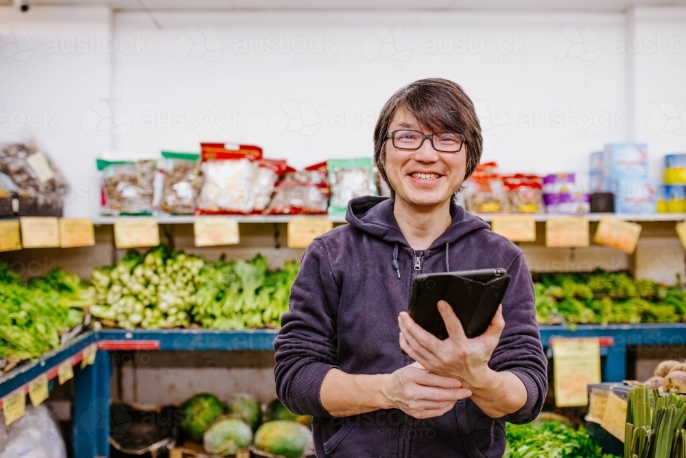 Image of Chinese man working in fresh food store - Austockphoto
