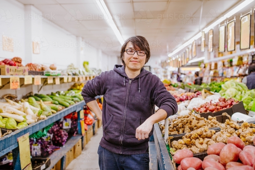 Image of Chinese man working in fresh food store - Austockphoto