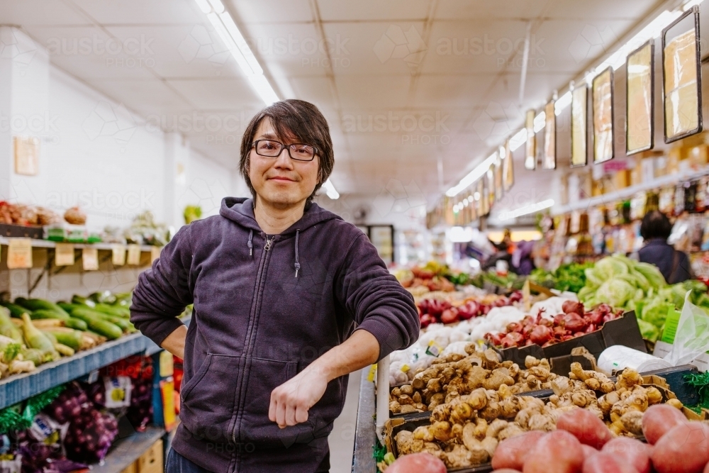 Image of Chinese man working in fresh food store - Austockphoto