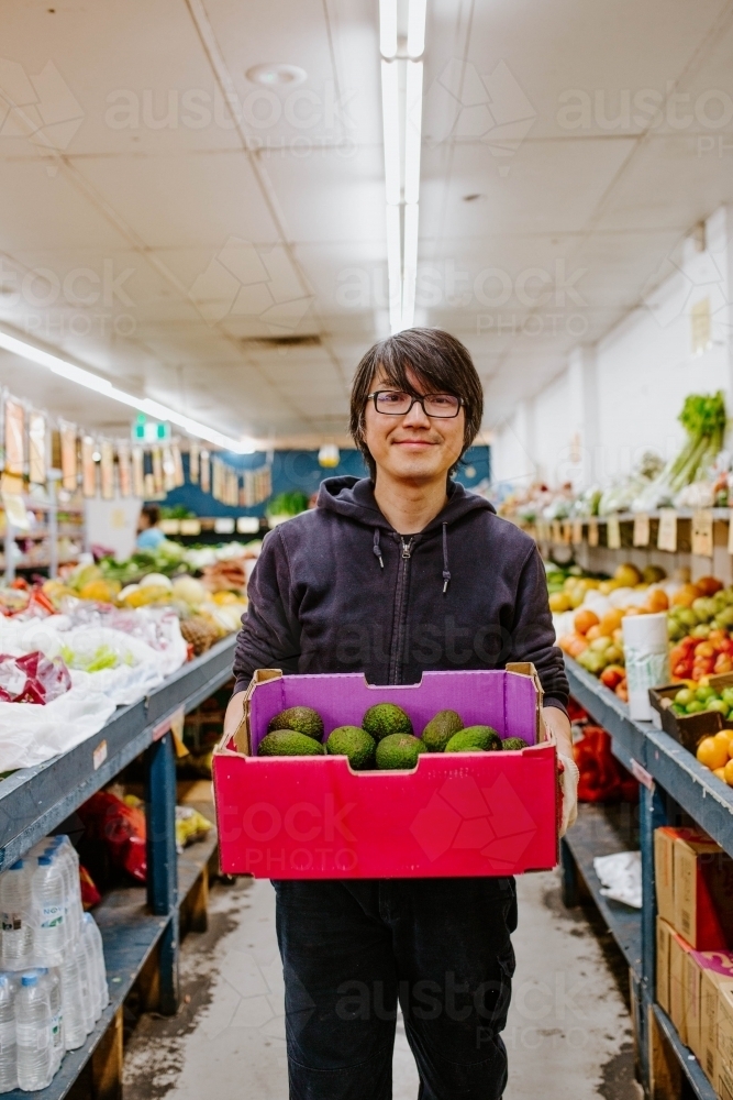 Image of Chinese man working in fruit supermarket - Austockphoto