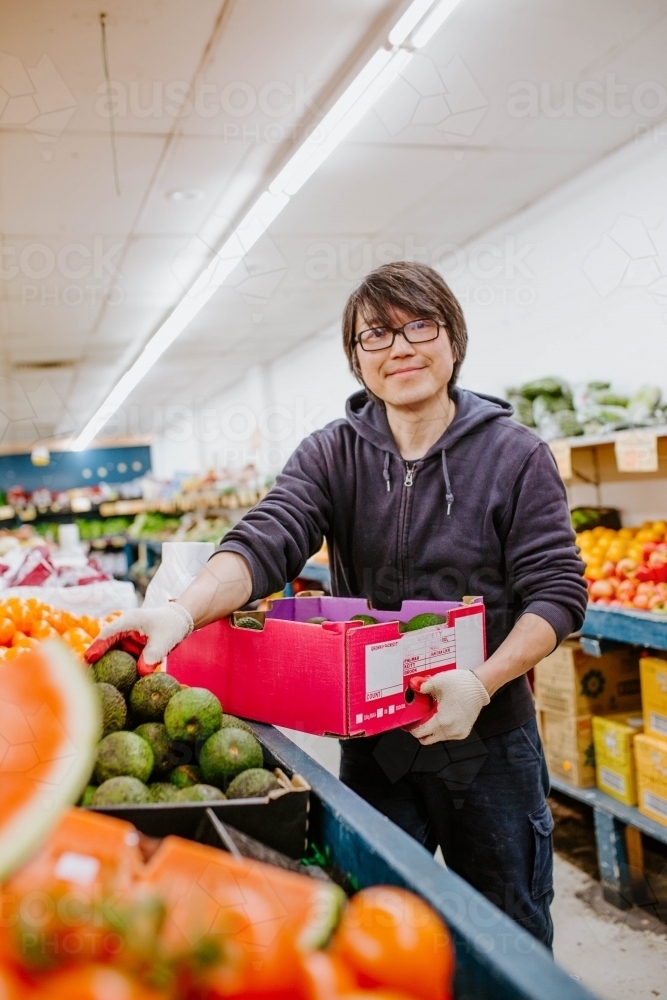 Image of Chinese man working in fruit supermarket - Austockphoto