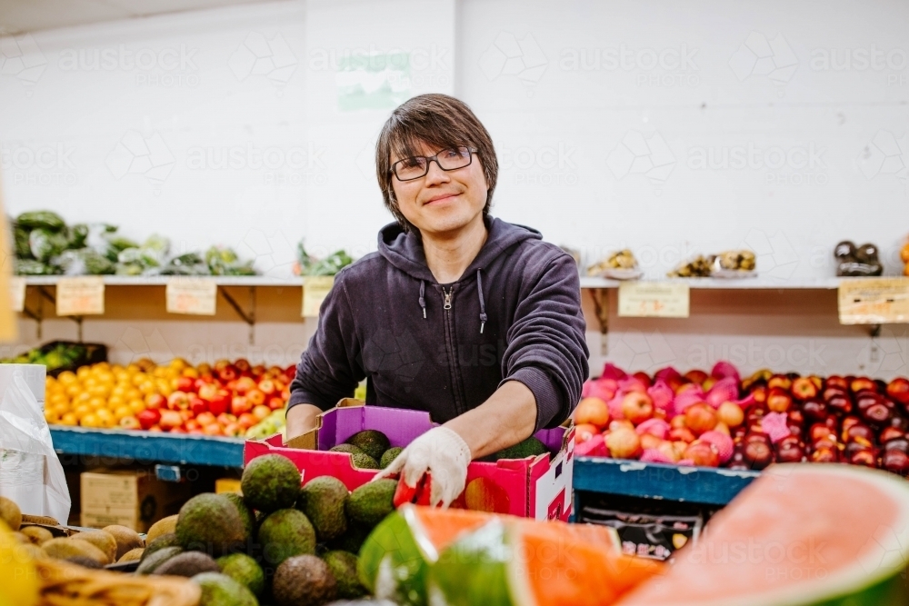 Image of Chinese man working in fruit supermarket - Austockphoto
