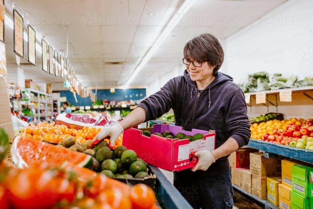 Image of Chinese man working in fruit supermarket - Austockphoto