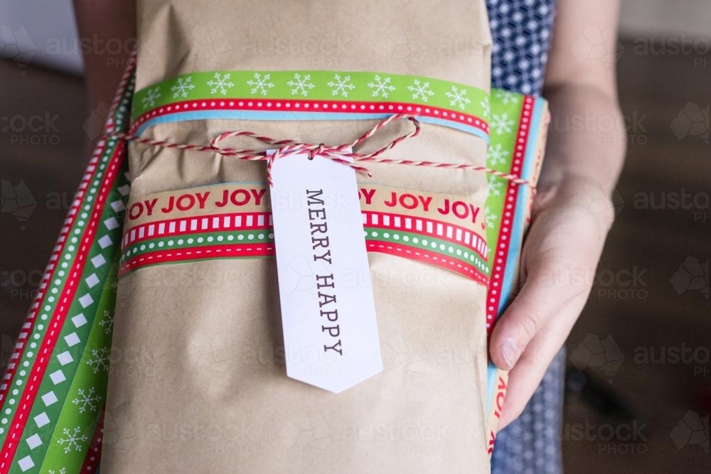 Image of christmas present with fun generic gift tag - Austockphoto