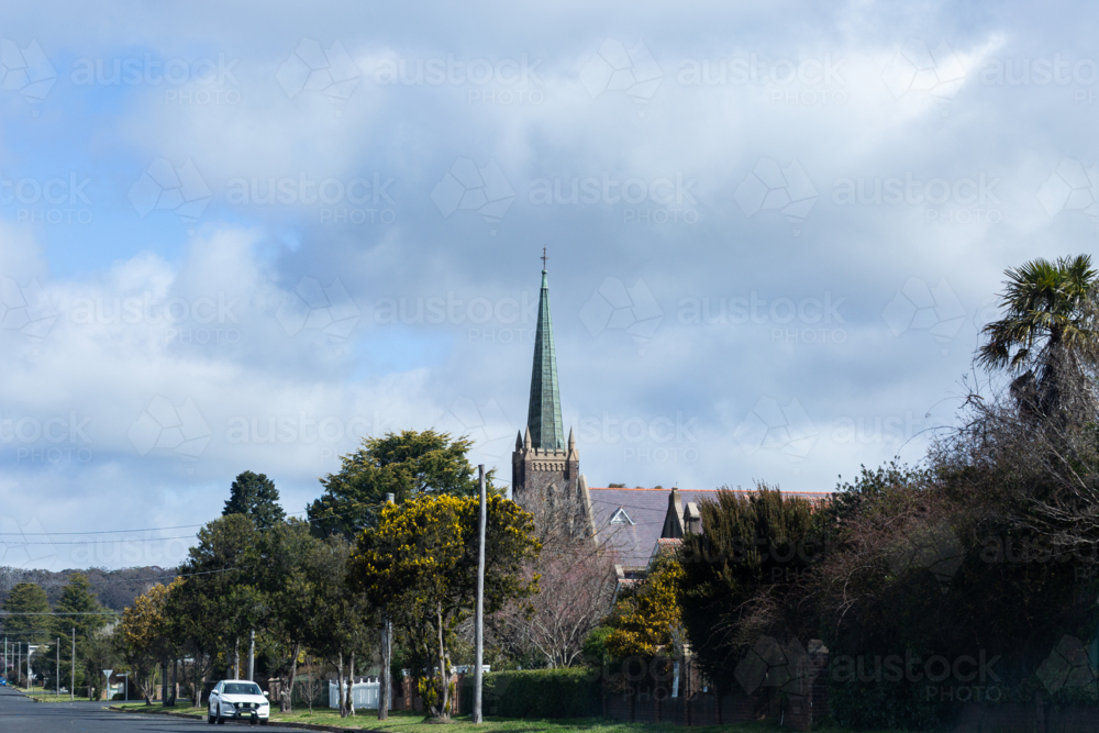 Image of church spire above treetops and bushes in winter in Glen Innes ...