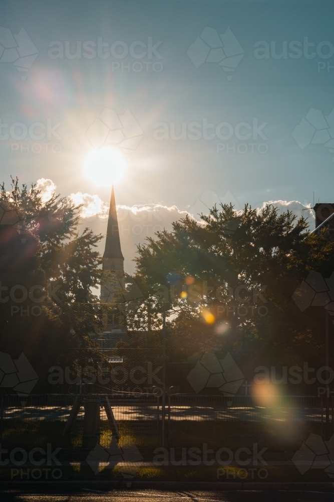 Image of Church steeple visible through bright afternoon light in small ...