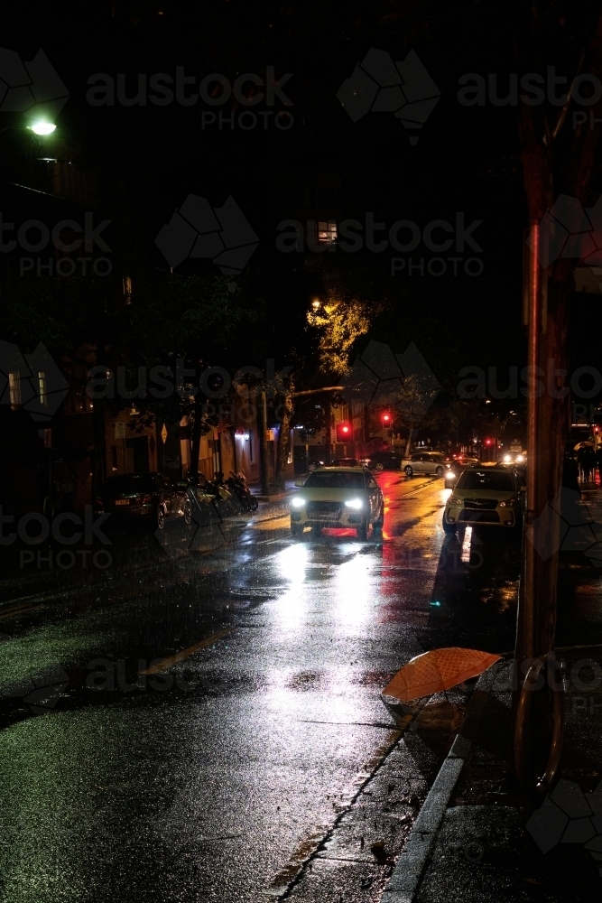 Image of City street at night with cars - Austockphoto