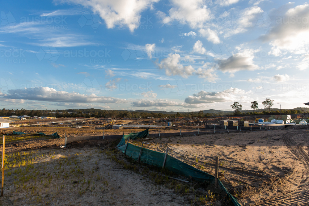 Image of cleared blocks of land under a blue sky ready for housing ...