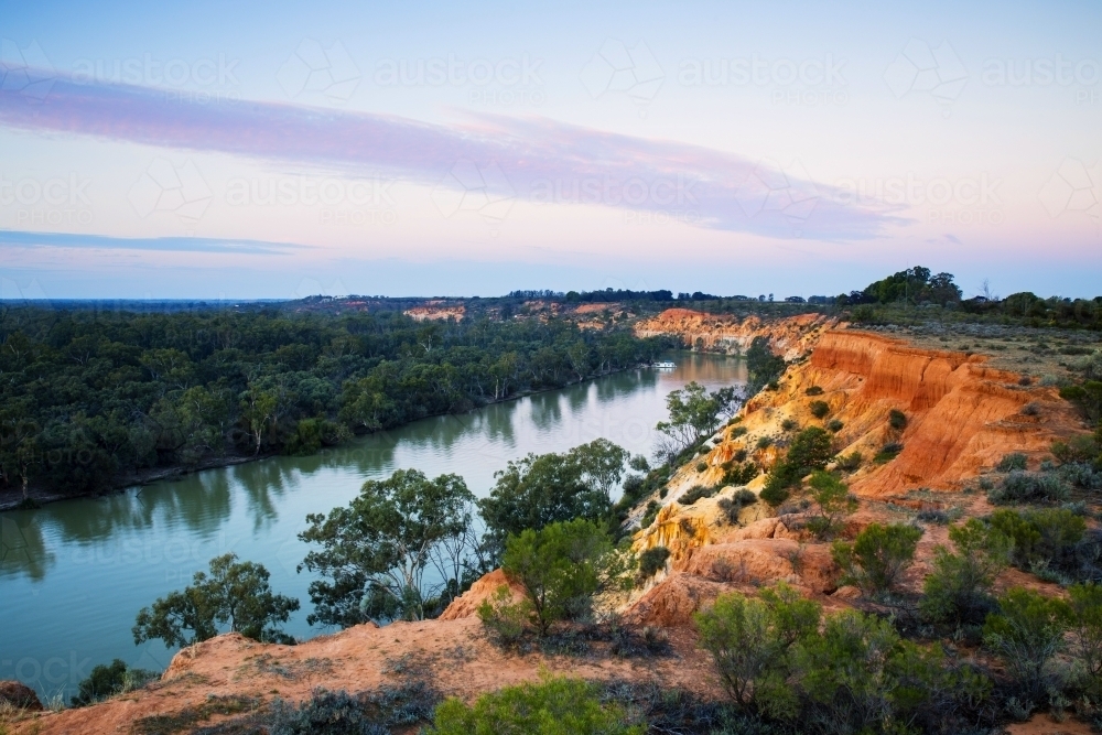 Image of Cliff faces and river at sunset - Austockphoto