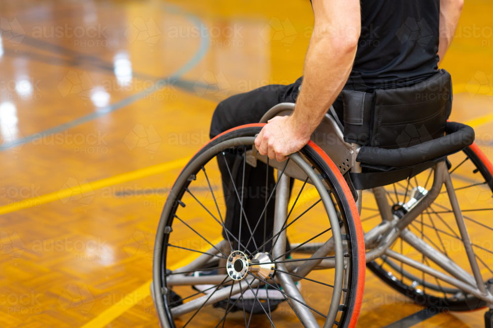 Image of close image of the lower half of a man in a wheelchair on a ...