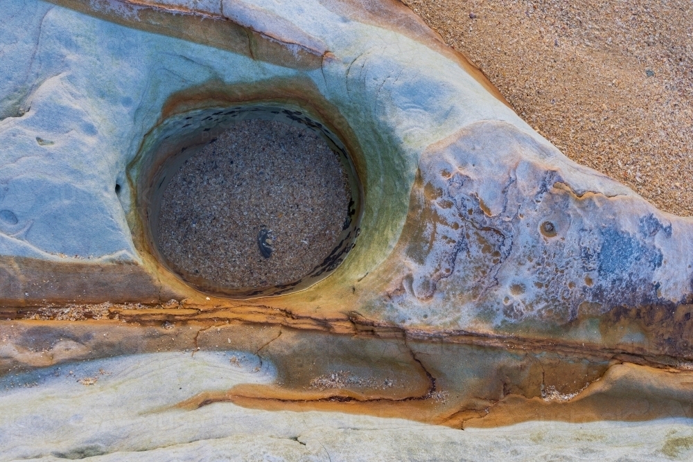Image of Close up detail of a circular pool filled with sand in a multi ...
