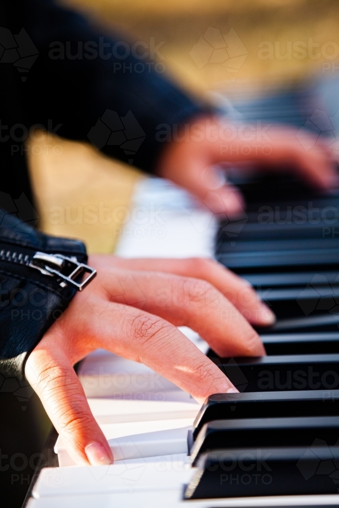 Image of Close up detail of boy playing keyboard keys - Austockphoto