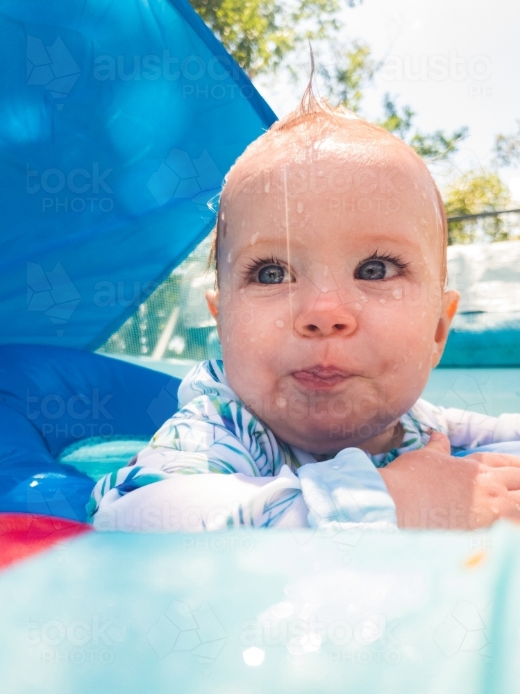 Image of close up of a baby experiencing swimming for the first time ...