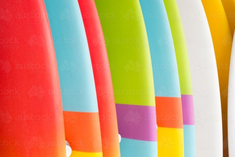 Image of Close up of colorful surfboards in a row - Austockphoto