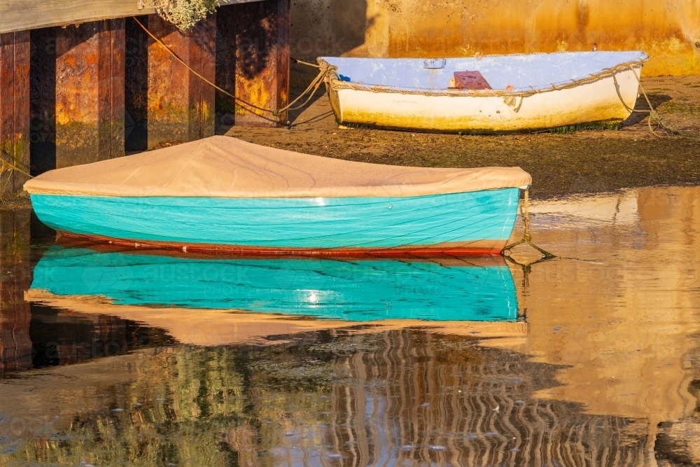 Image of Close up of colourful row boats reflecting on still water ...