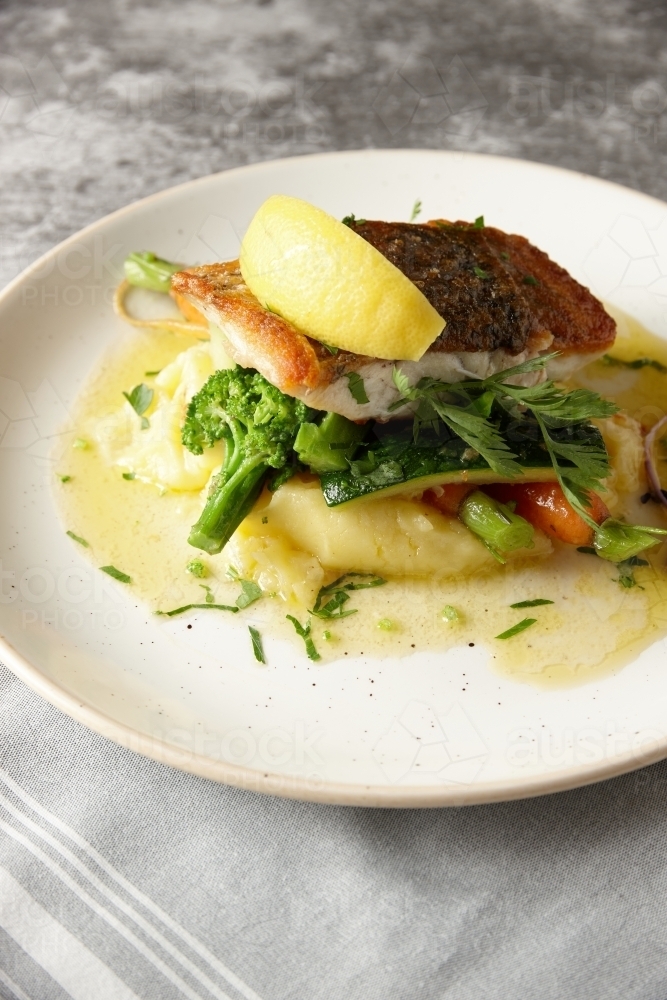 Image of Close up of delicious barramundi dish on plate - Austockphoto
